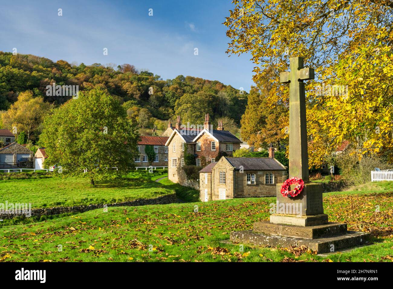 Autumn leaves in the village green and stone cottages at moorland ...