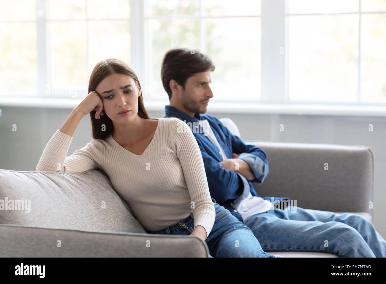 Sad depressed young caucasian wife ignores unhappy husband sitting on ...