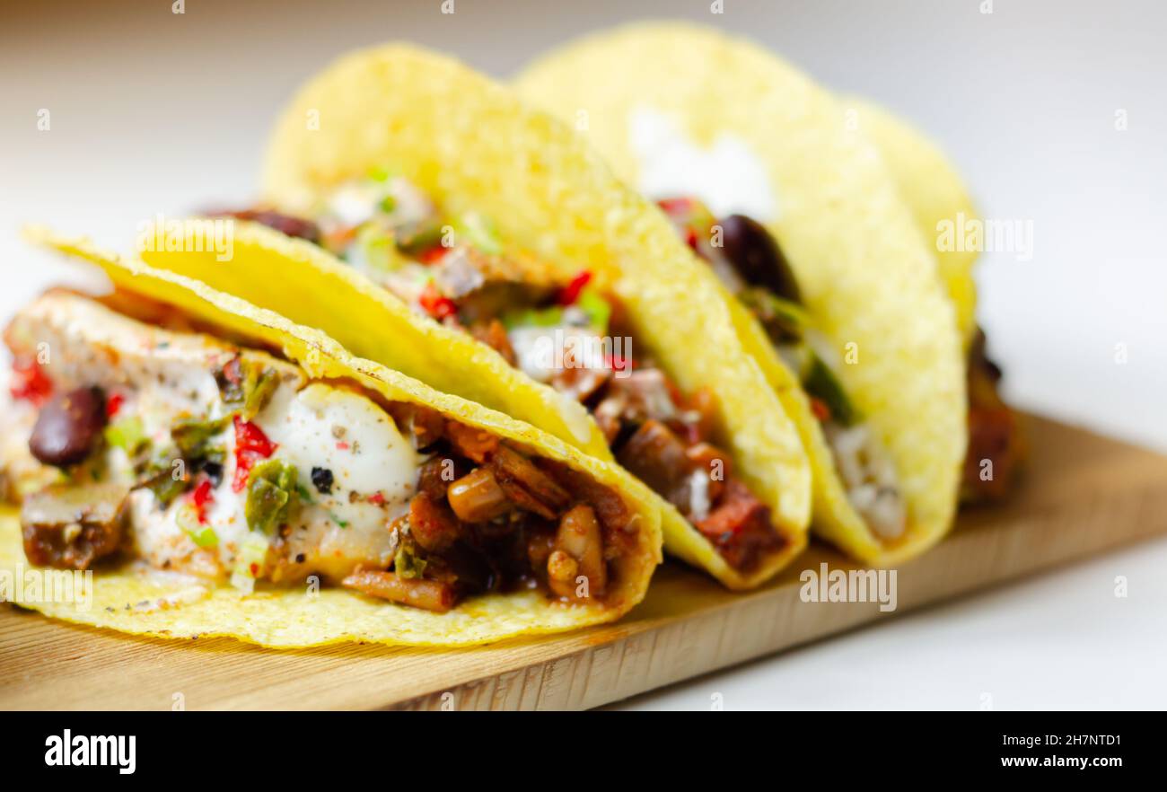 Mexican tacos shells with chicken and red kidney beans, onion, red and ...