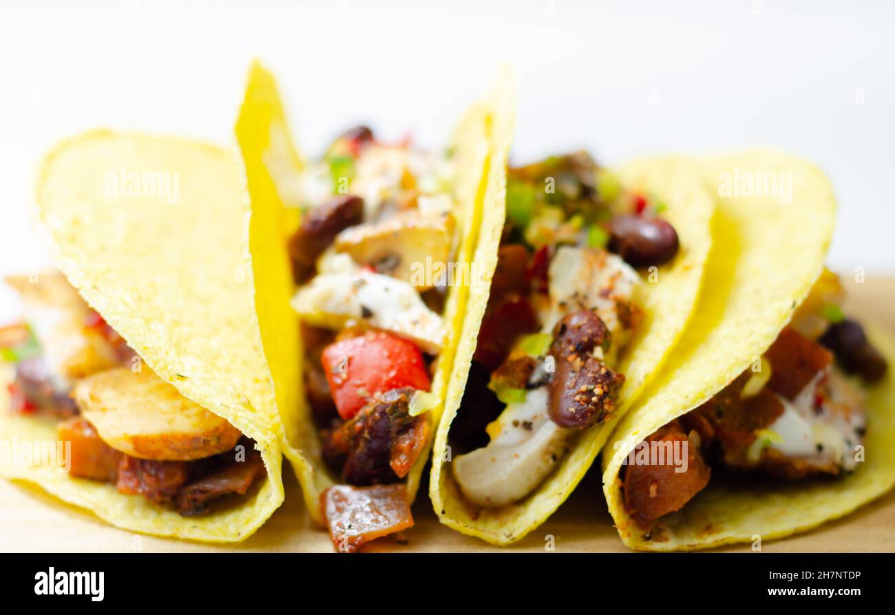 Mexican tacos shells with chicken and red kidney beans, onion, red and ...