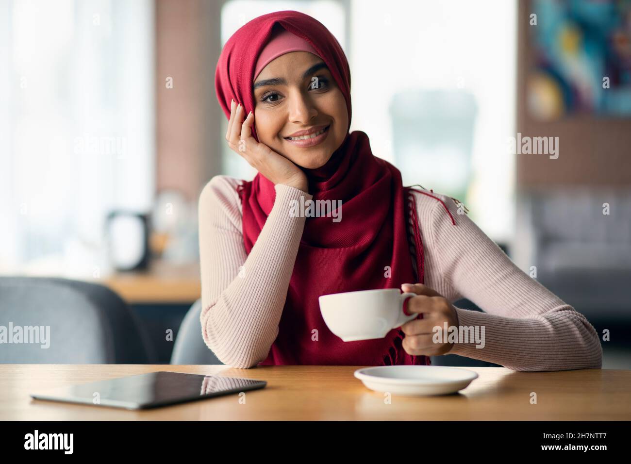 Cute arabic lady in hijab drinking coffee at cafe Stock Photo - Alamy