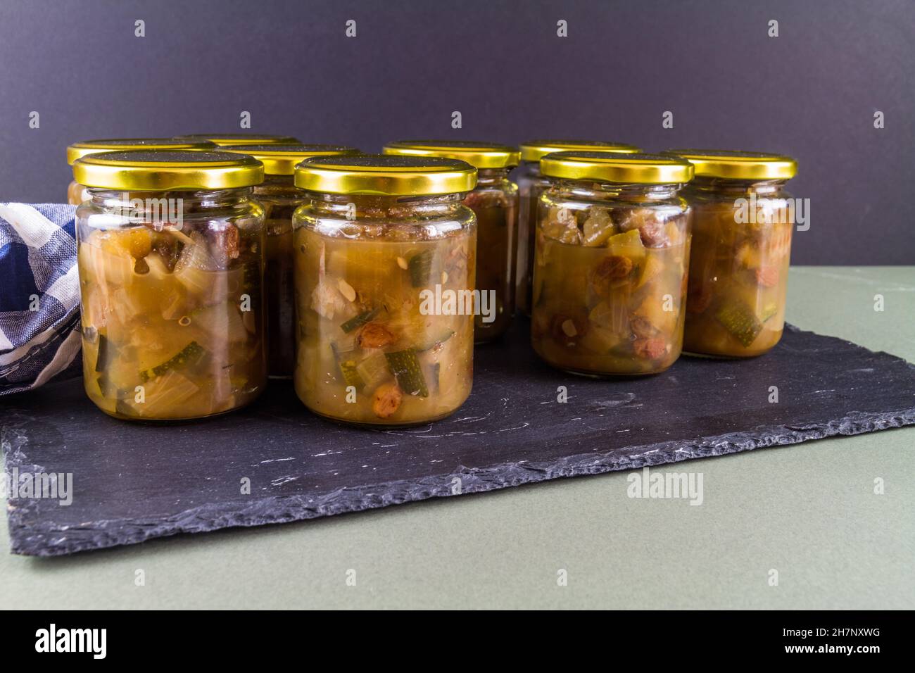 Chutney after courgette grew into marrow. Several jars black dark ...