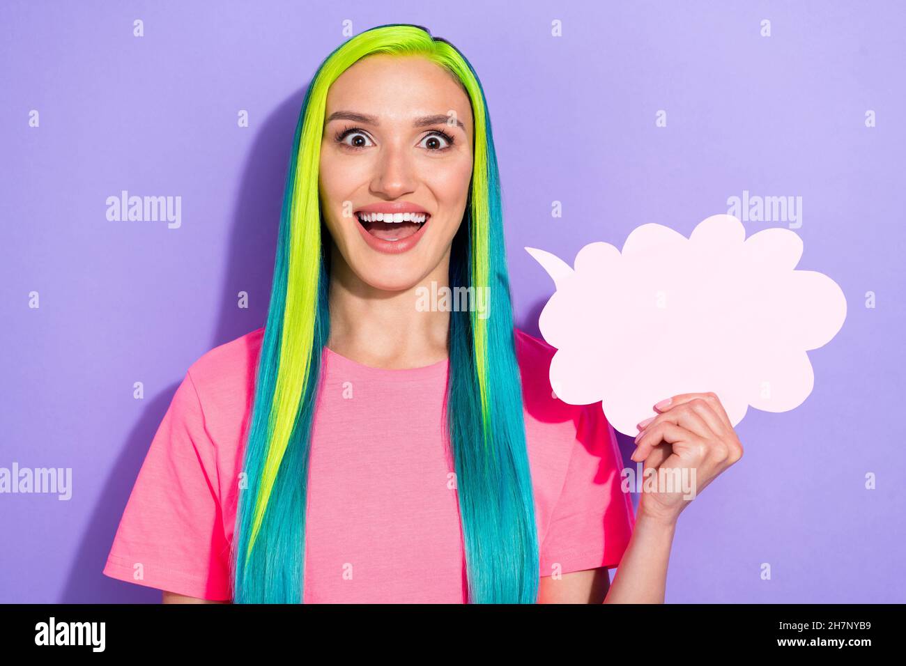 Portrait of surprised lady with vivid hairstyle wig hold paper card ...