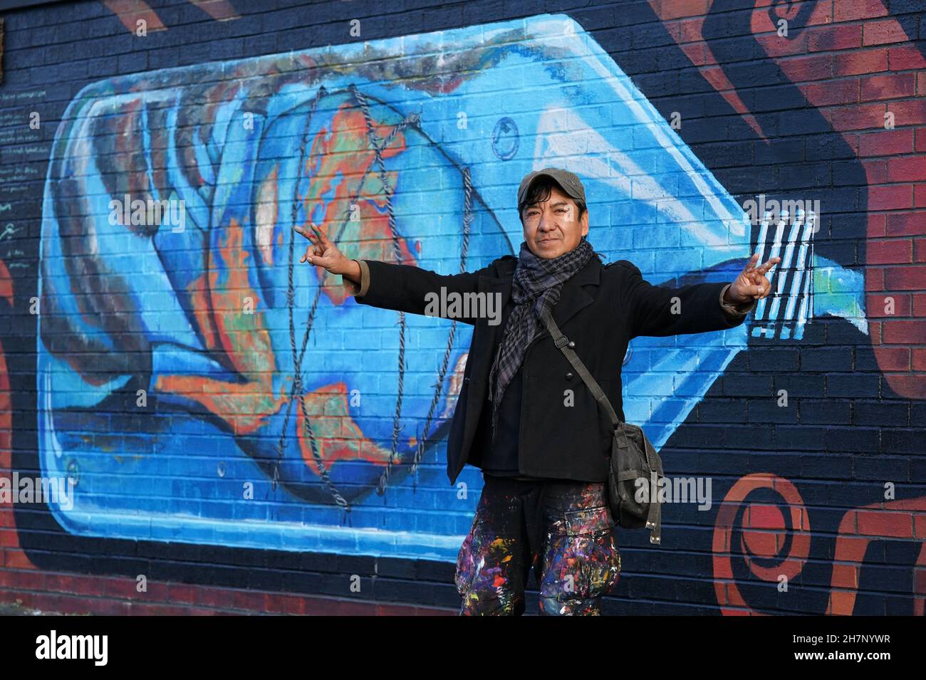 Mexican artist and activist, Gustavo Chavez Pavon in front of mural he ...