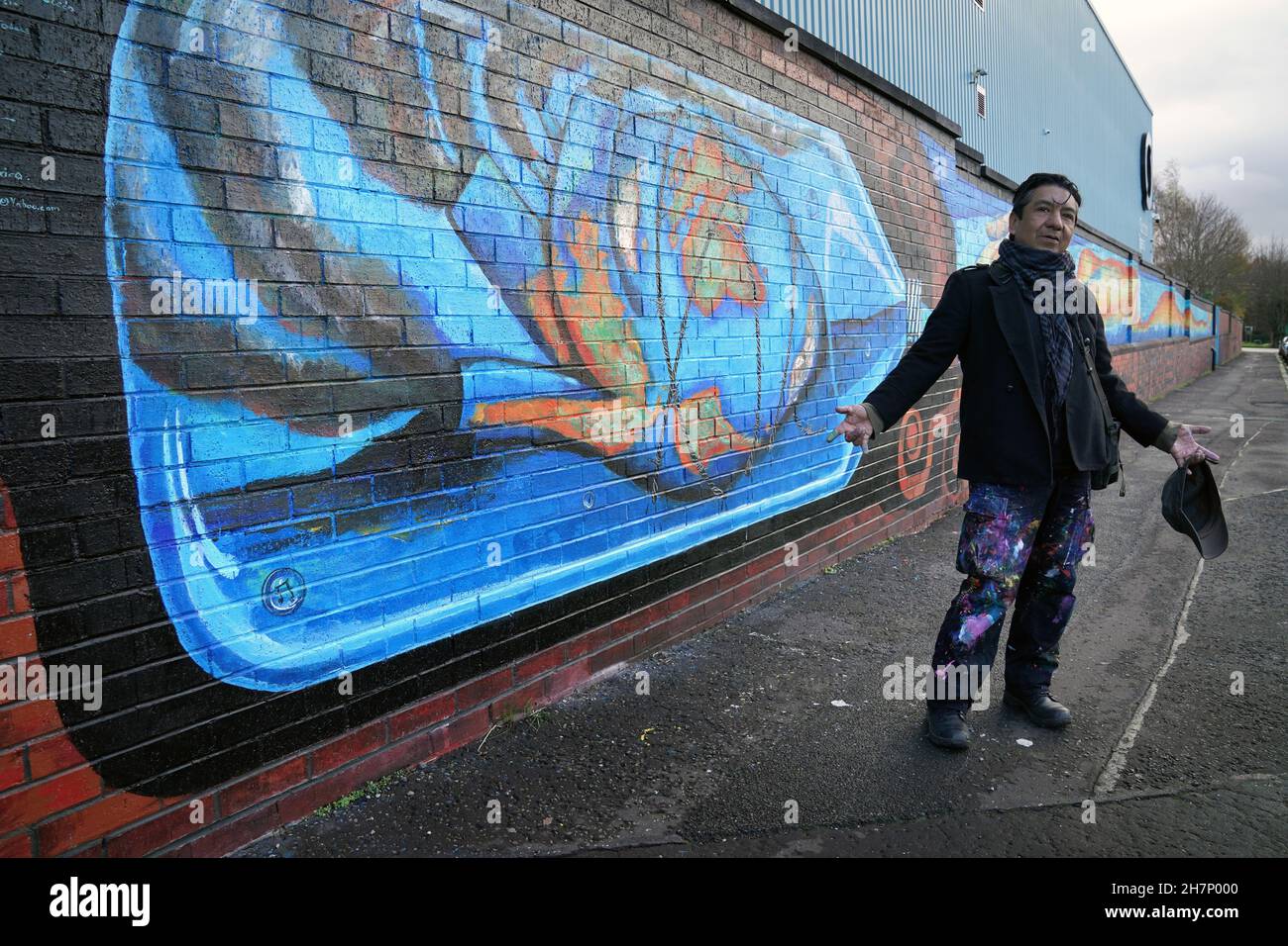 Mexican artist and activist, Gustavo Chavez Pavon in front of mural he ...