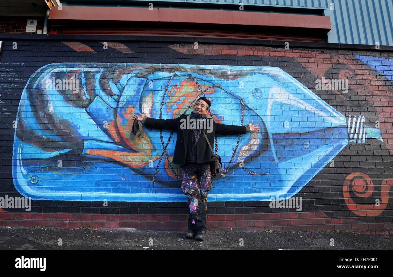 Mexican artist and activist, Gustavo Chavez Pavon in front of mural he ...