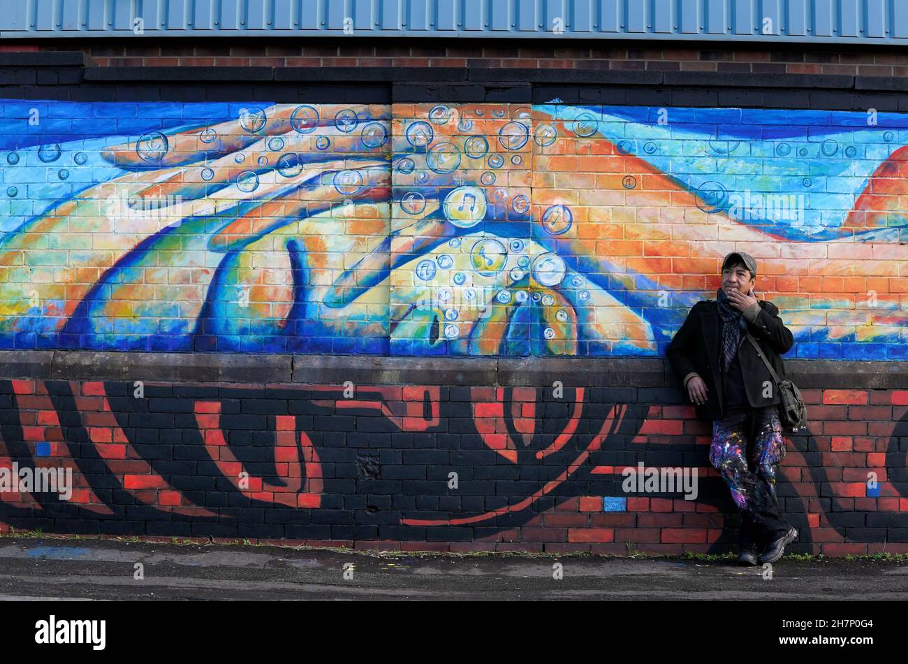 Mexican artist and activist, Gustavo Chavez Pavon in front of mural he ...