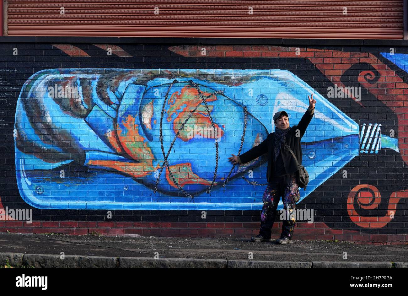 Mexican artist and activist, Gustavo Chavez Pavon in front of mural he ...