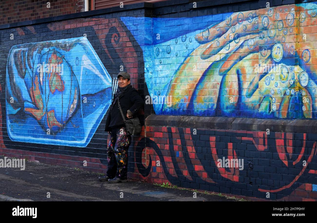 Mexican artist and activist, Gustavo Chavez Pavon in front of mural he ...