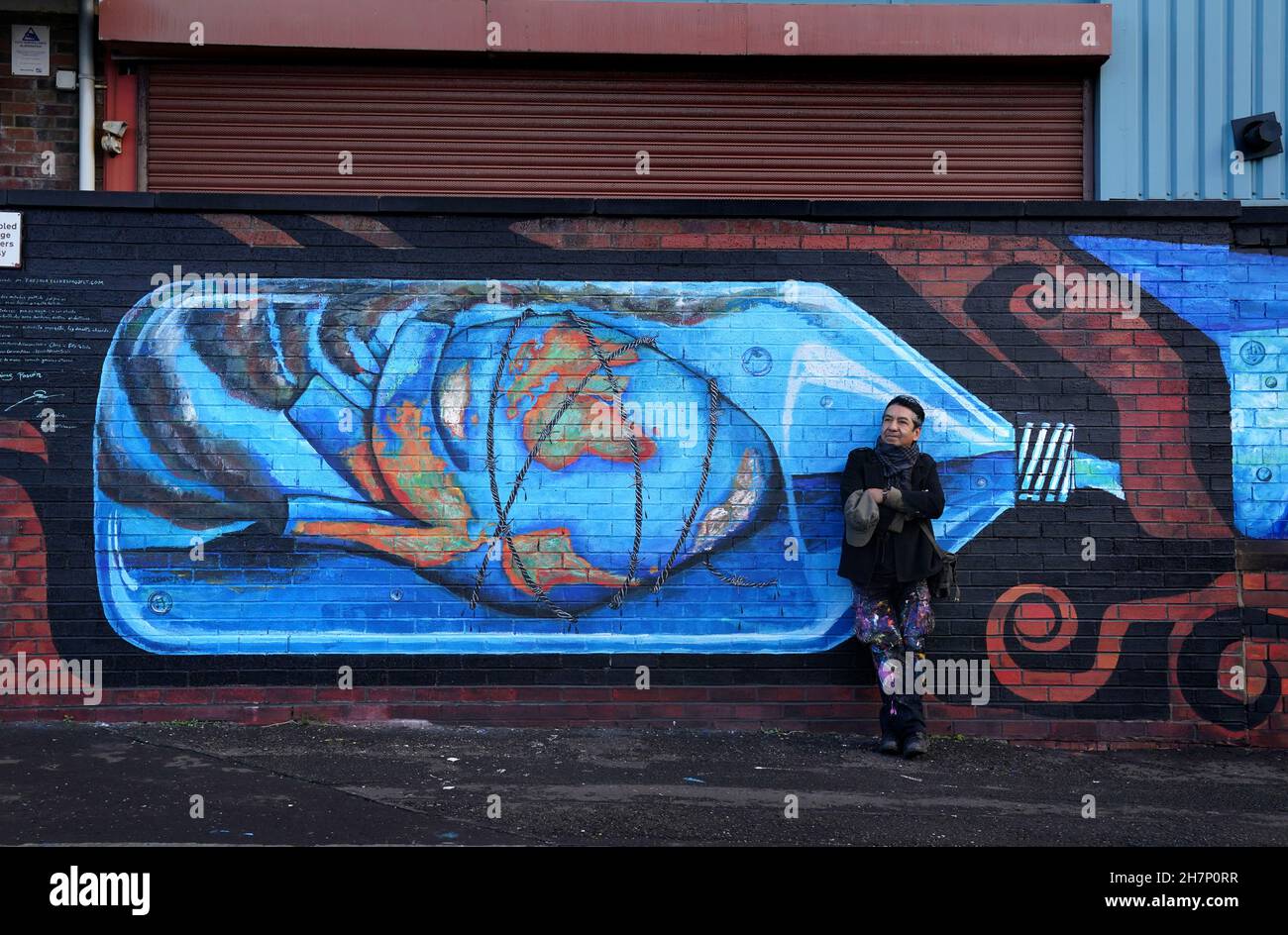 Mexican artist and activist, Gustavo Chavez Pavon in front of mural he ...