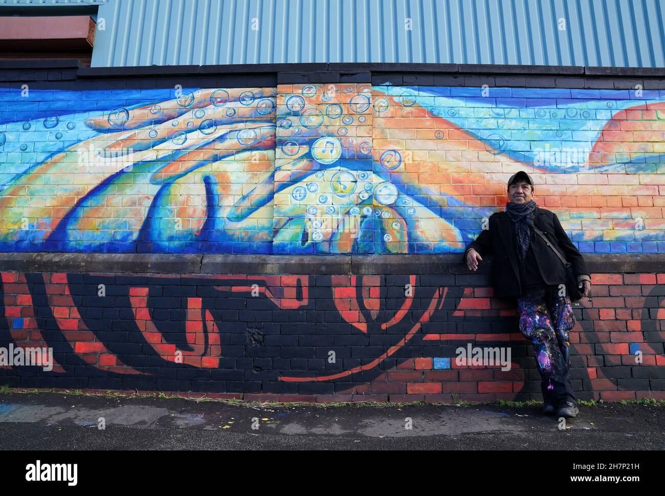 Mexican artist and activist, Gustavo Chavez Pavon in front of mural he ...