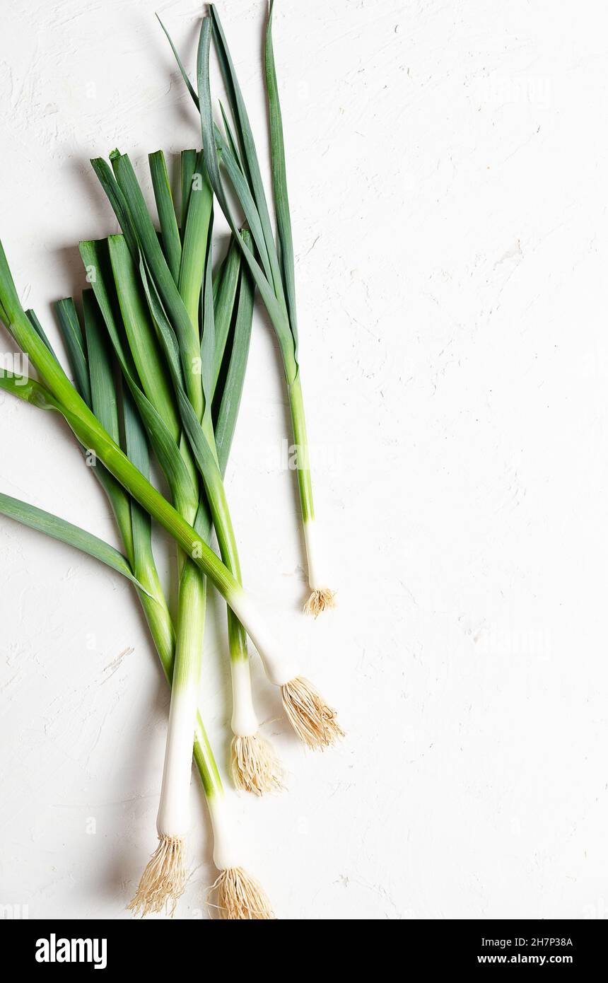 A bunch of fresh leeks on a white background Stock Photo - Alamy