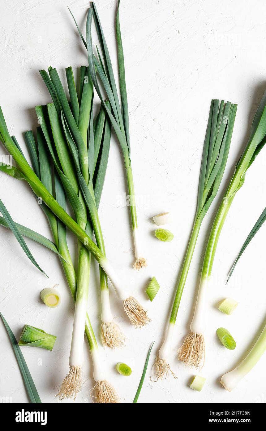 A bunch of fresh leeks on a white background Stock Photo - Alamy