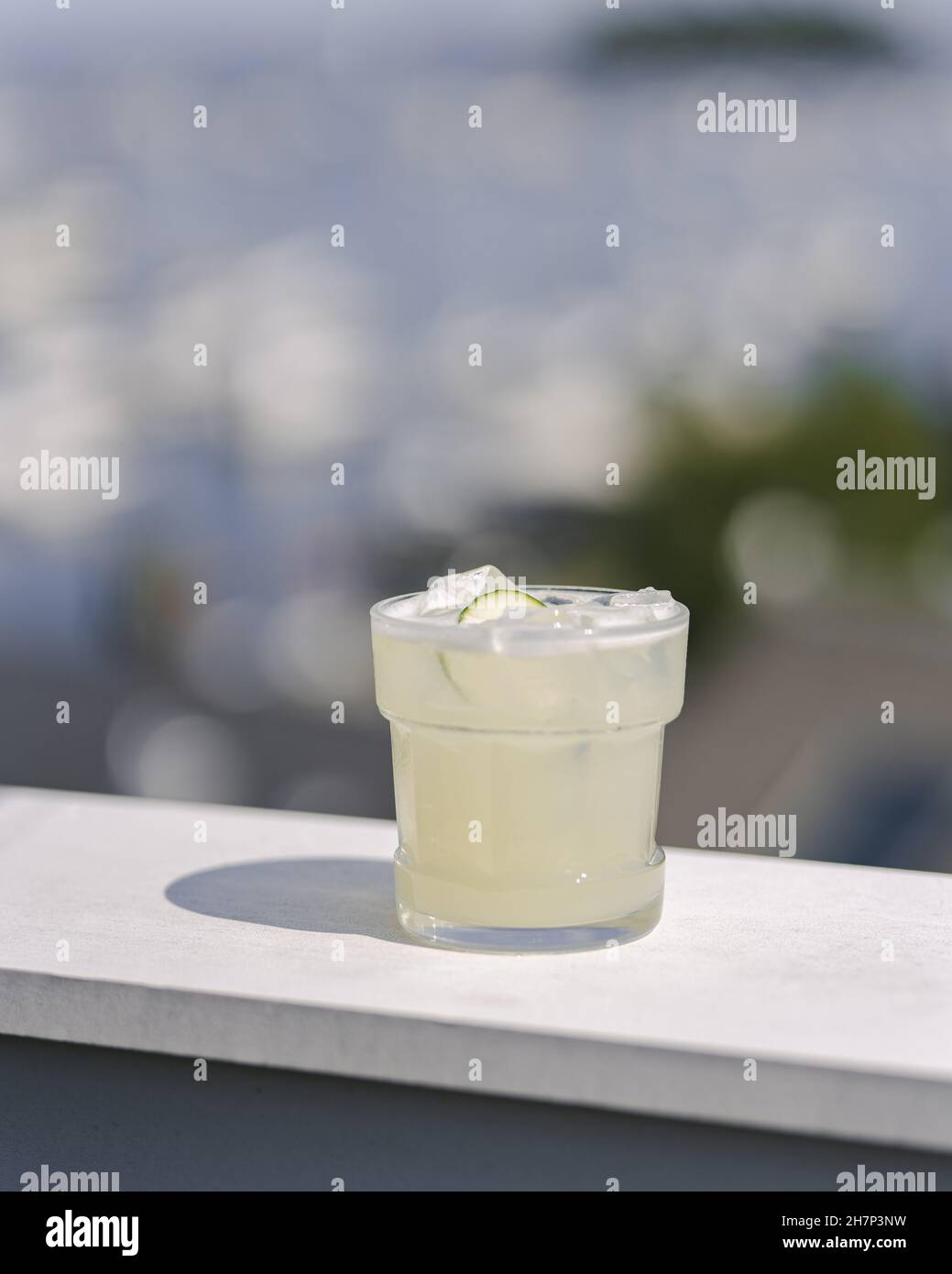Limeade Fizz with alcohol and lime garnish at fancy rooftop bar Stock ...