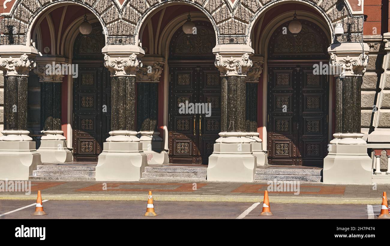 Three-door entrance with columns in a large old building Stock Photo ...