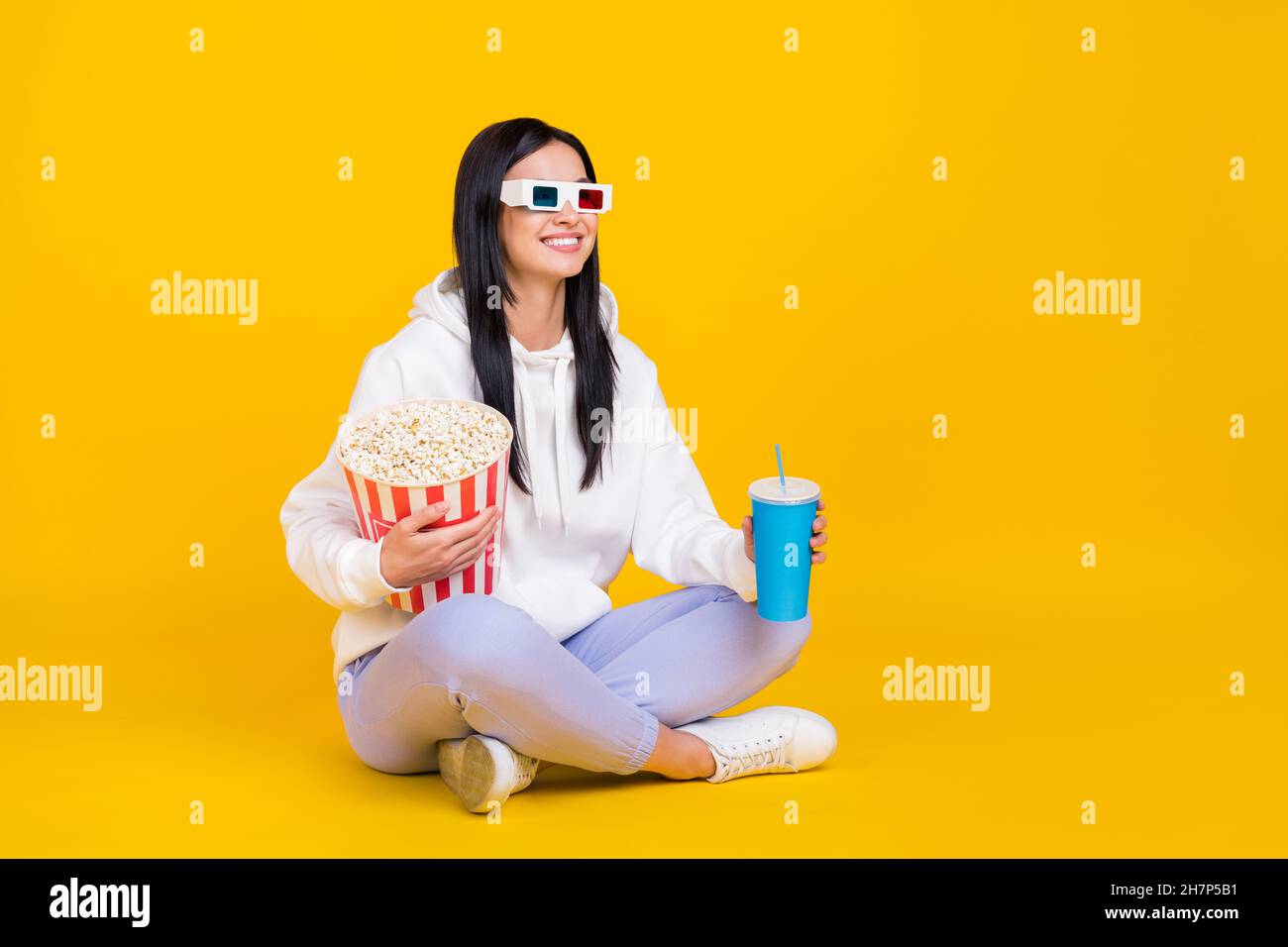 Photo of youth lady sit legs crossed hold popcorn basket takeout soda ...