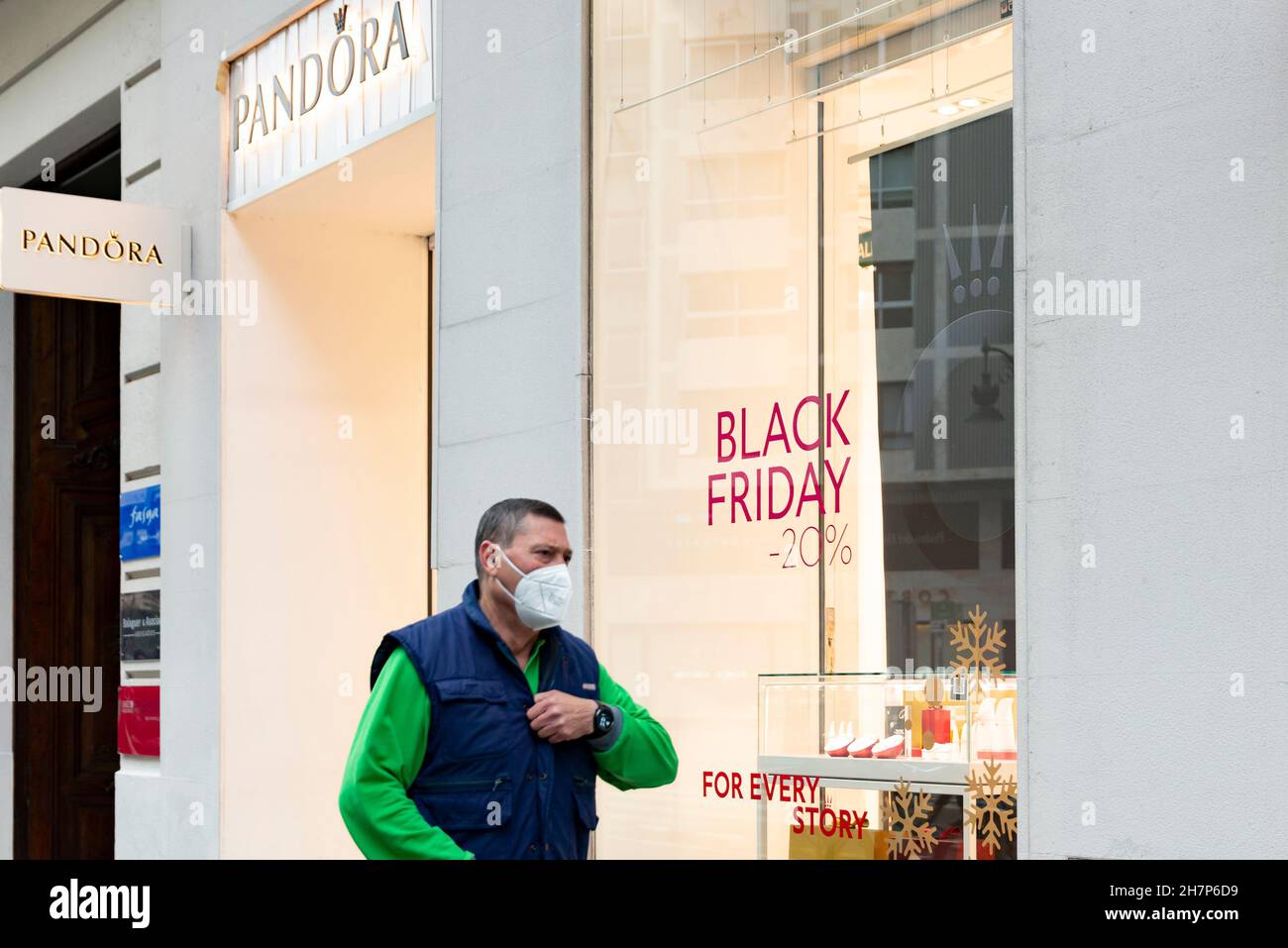 A man wearing a face mask as a precaution against the spread of covid ...