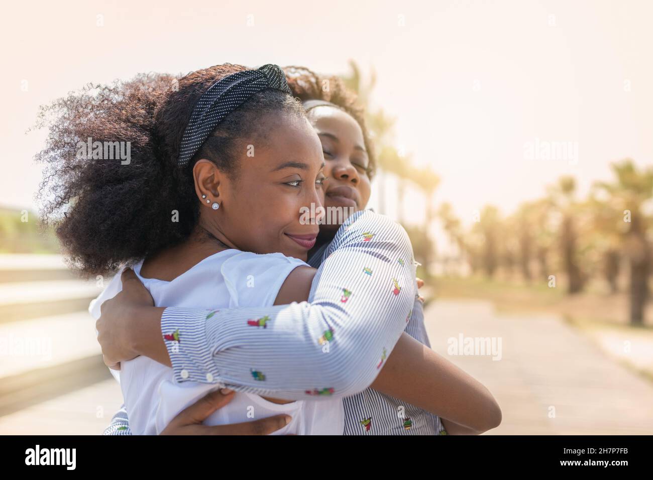 Happy meeting two friends hugging hi-res stock photography and images ...