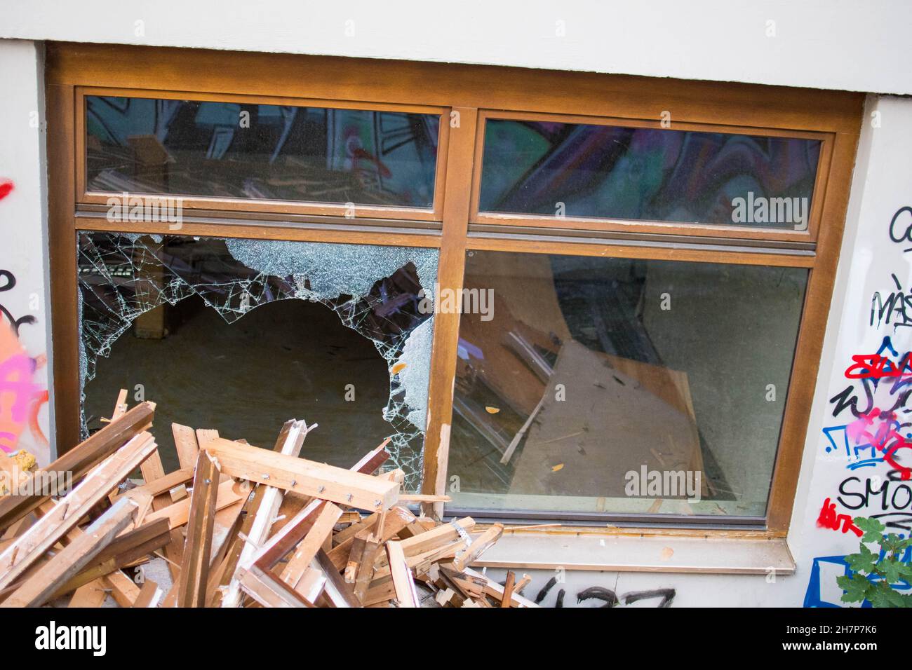 Building with destroyed pane and spilt glass Stock Photo - Alamy