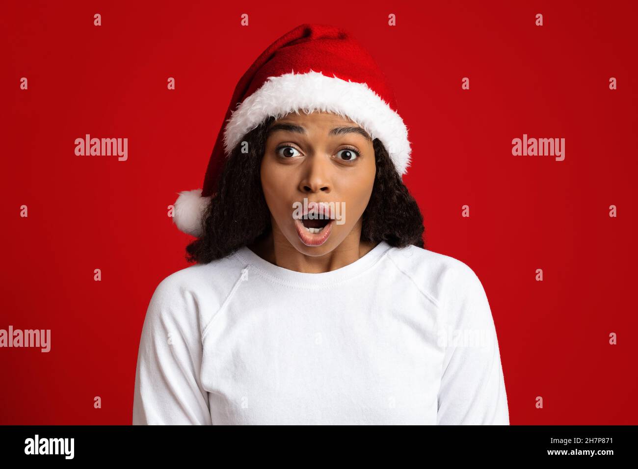 Surprised woman in santa hat hi-res stock photography and images - Alamy