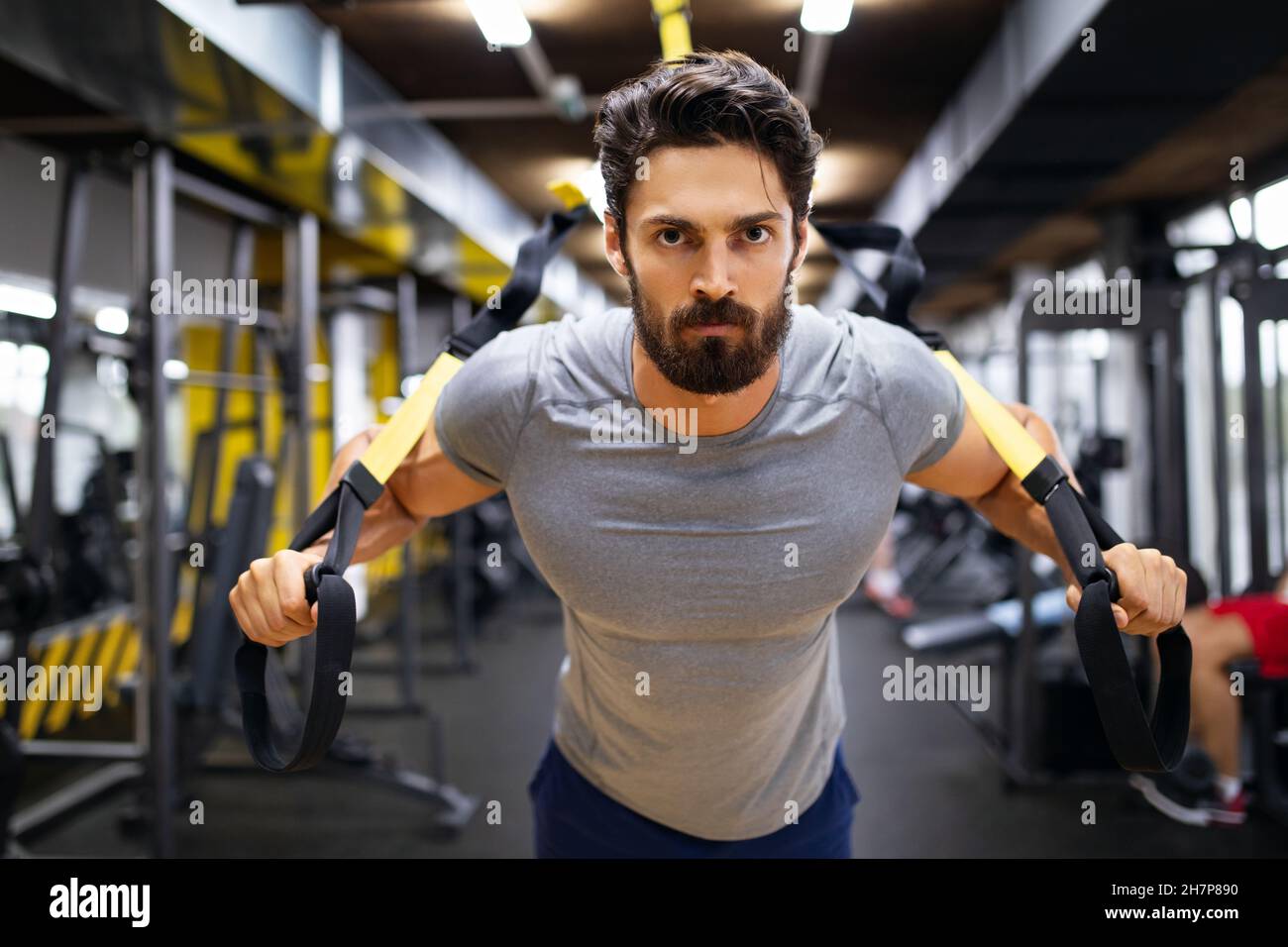 Muscular bodybuilder handsome man doing exercises in gym. Sport people ...