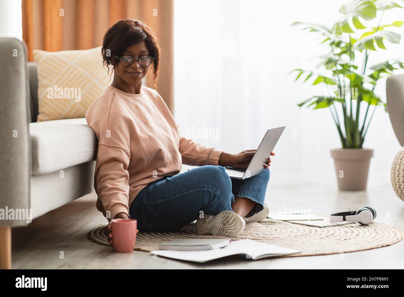 African Woman Using Laptop Stretching For Cup Drinking Coffee Indoor ...