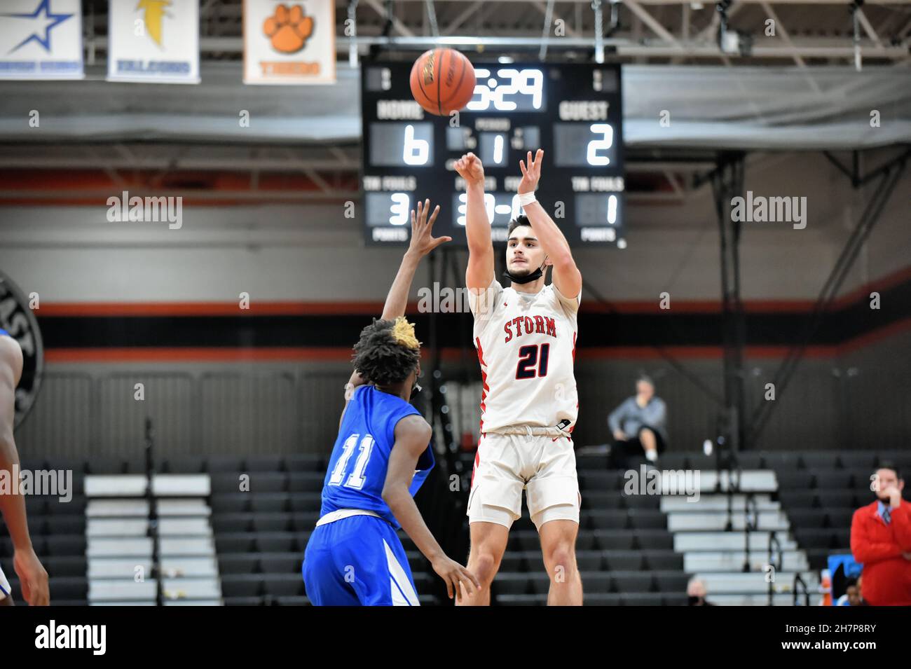 USA. Player firing off a three-point shot from behind the arc over a ...