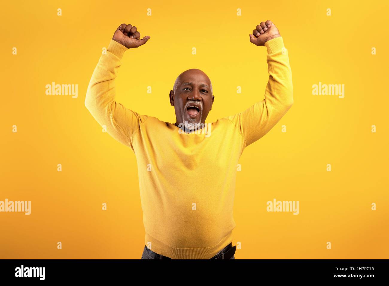 Overjoyed senior black man screaming in excitement, gesturing YES with ...