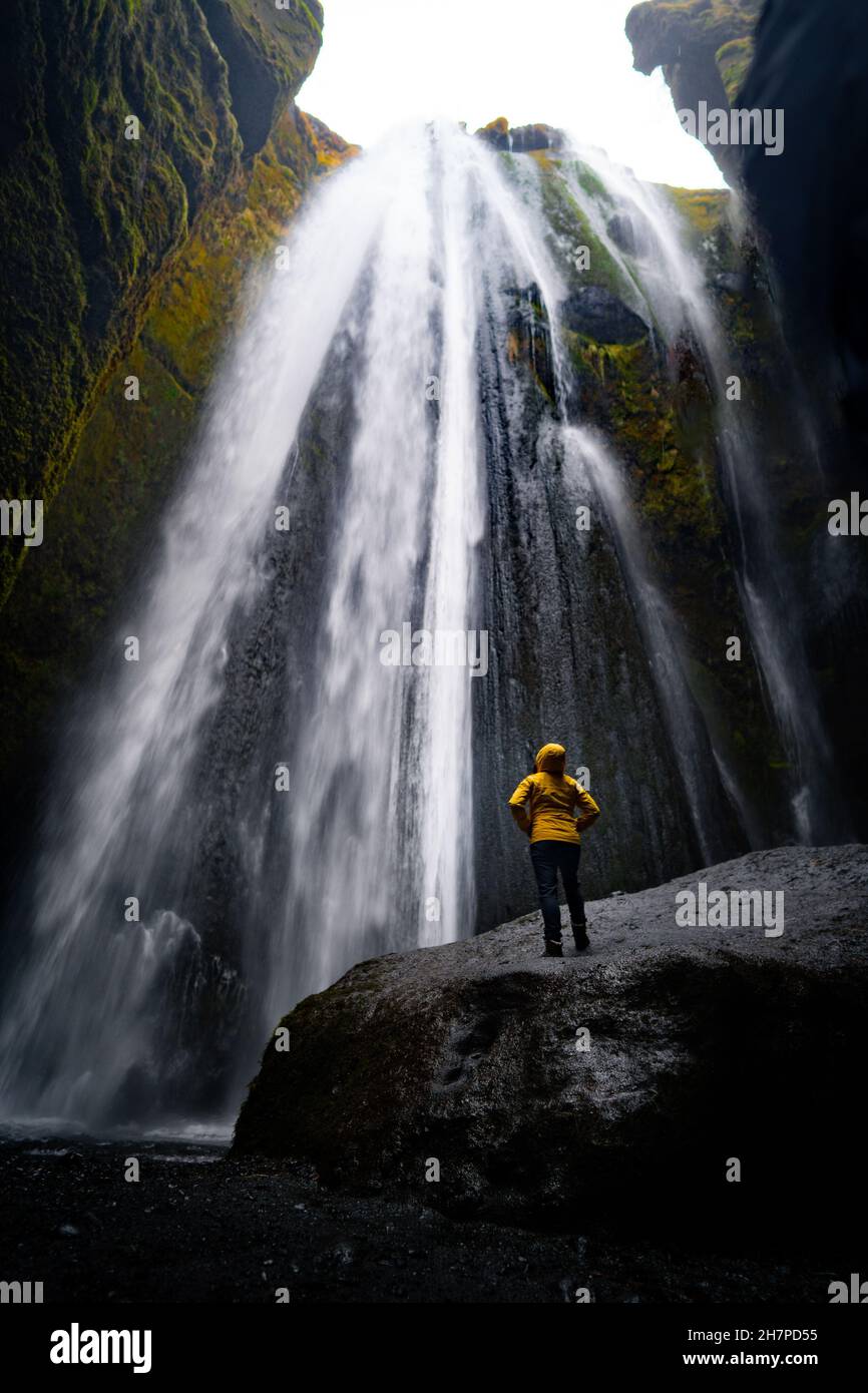 Traveler stunned by Gljufrabui waterfall cascade in Iceland. Location ...