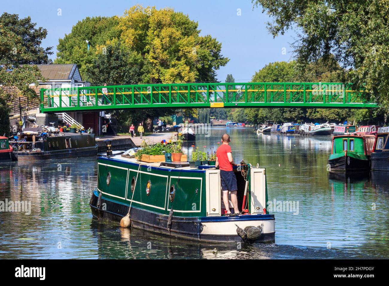 A man steers a narrowboat upriver past Springfield Marina on the River ...