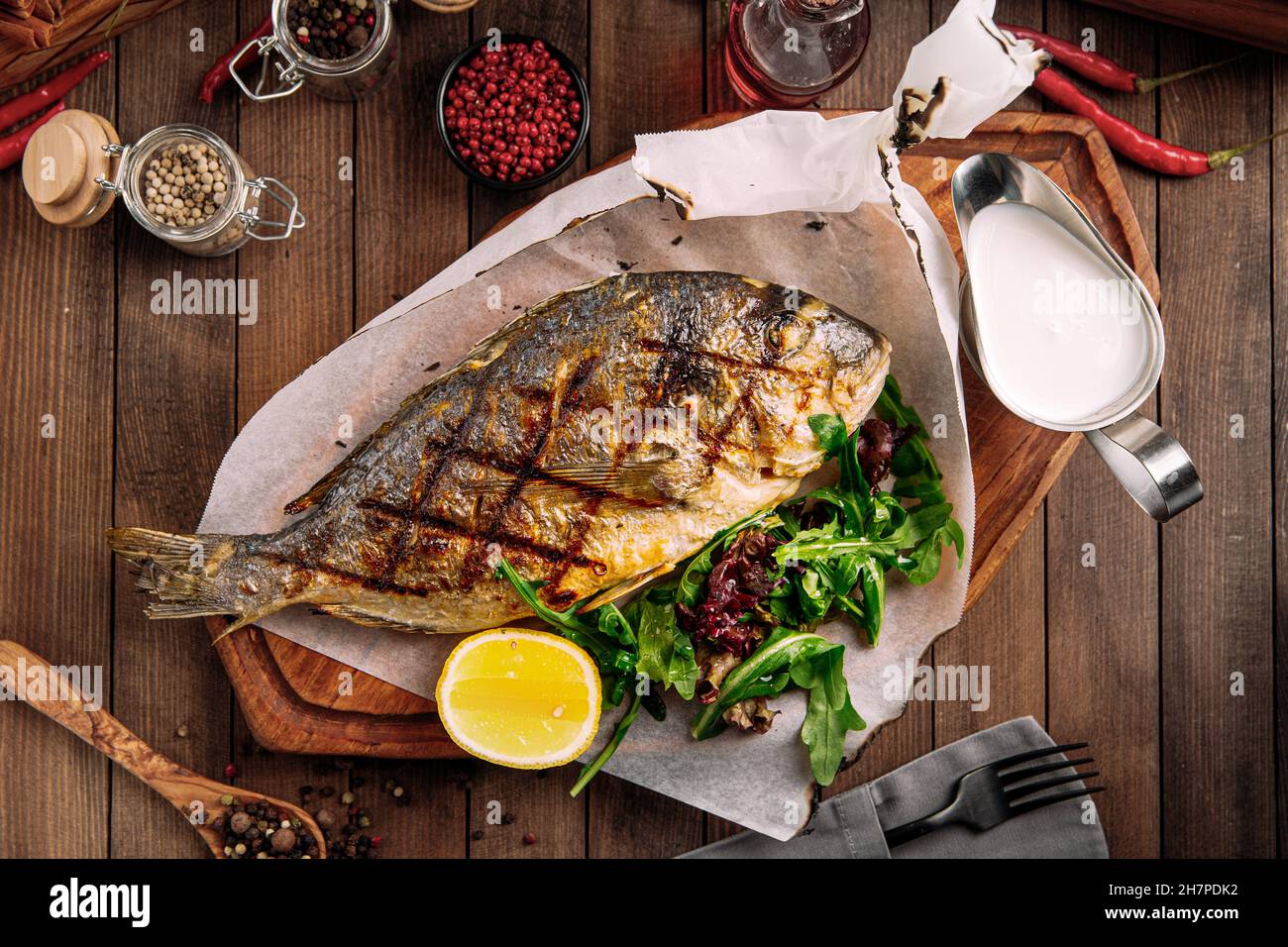Gourmet grilled dorado fish with greens Stock Photo - Alamy