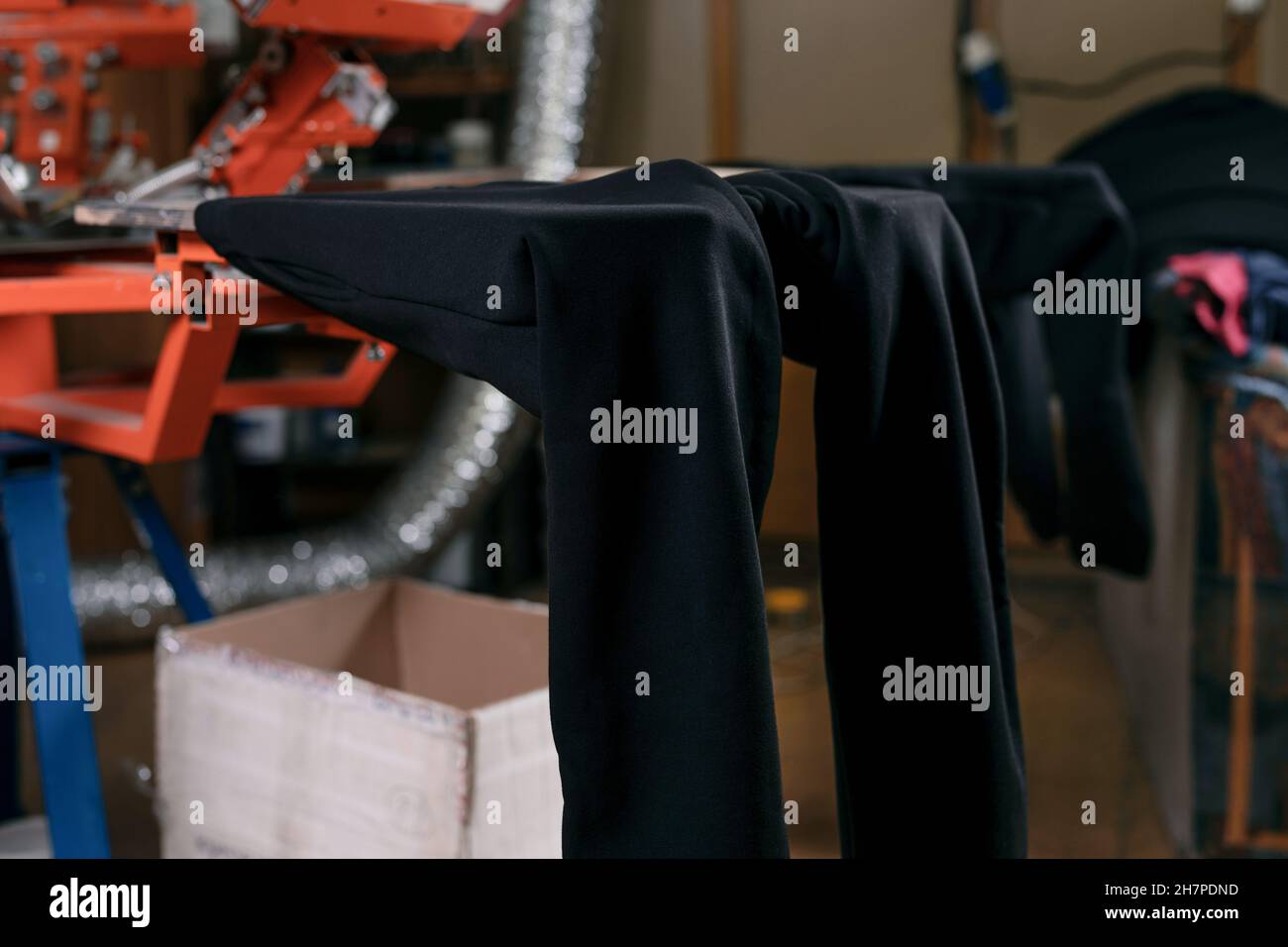 serigraphy production. printing on pants by silk screen. printing ...