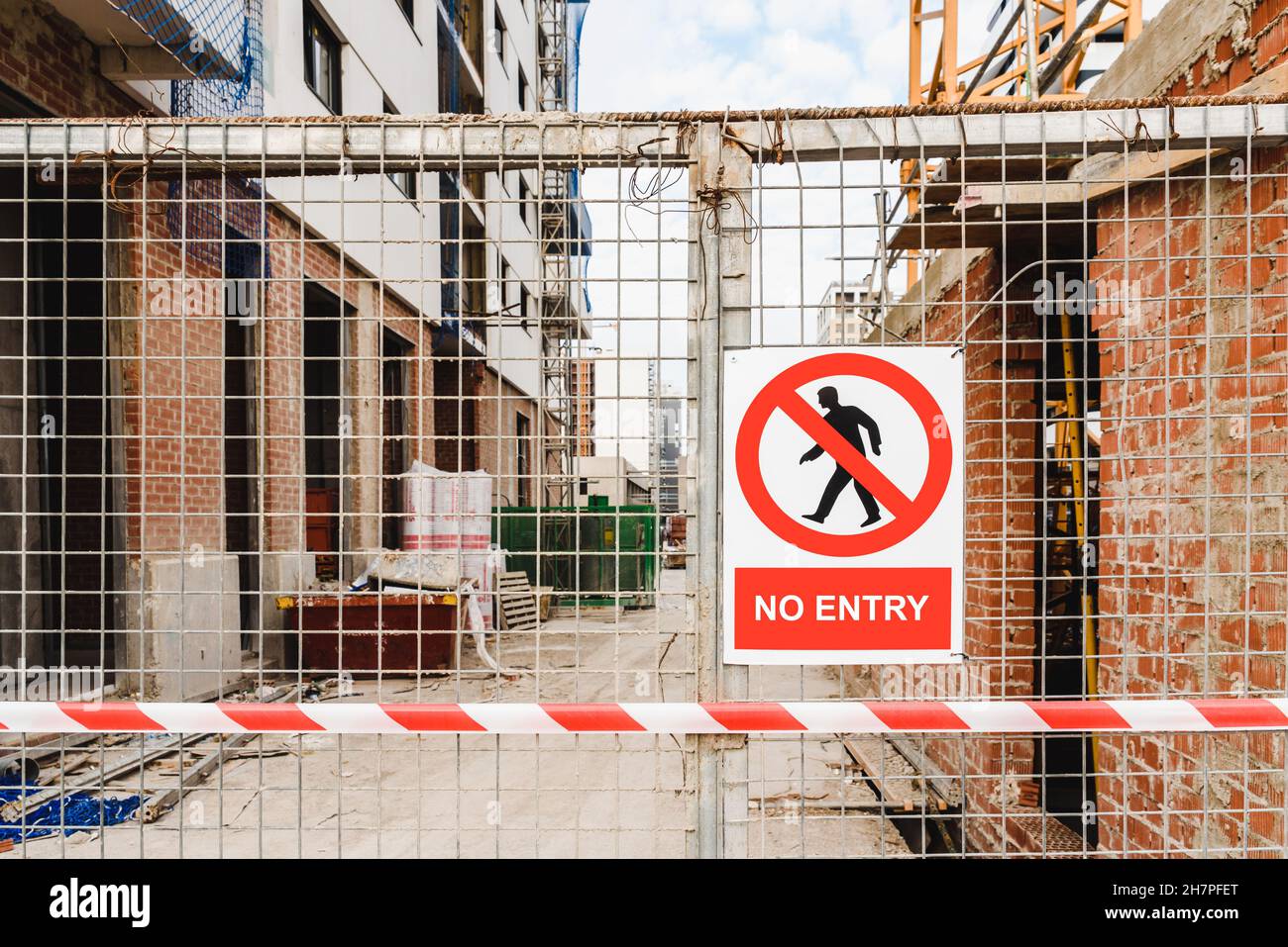 Closed access door to the construction site of a building, with a no ...