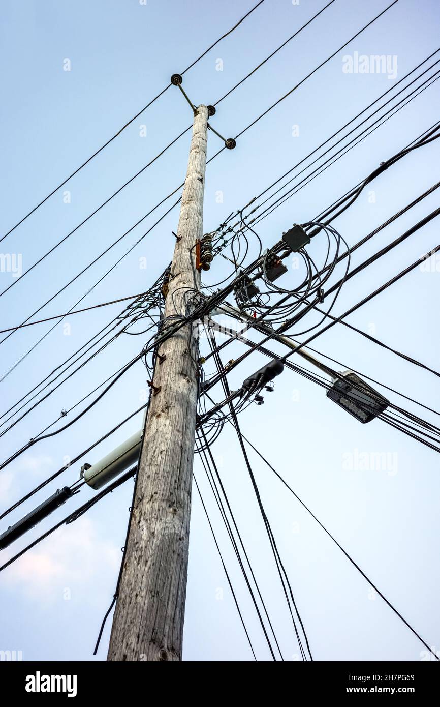 Cables, fiber optic cable and power lines on the pole Stock Photo - Alamy