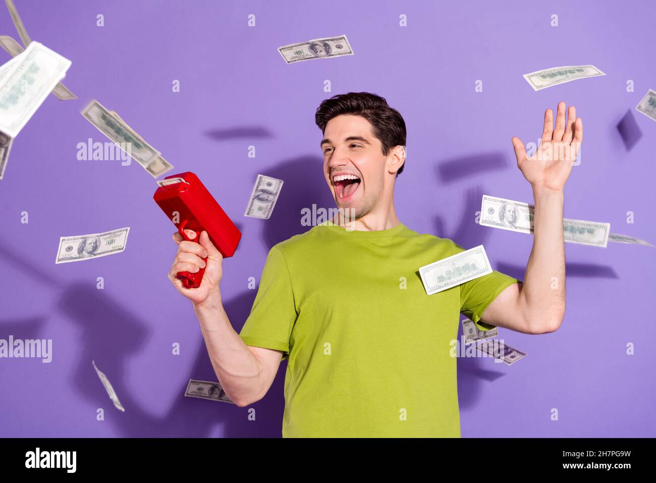 Green money gun shooting banknotes hi-res stock photography and images ...