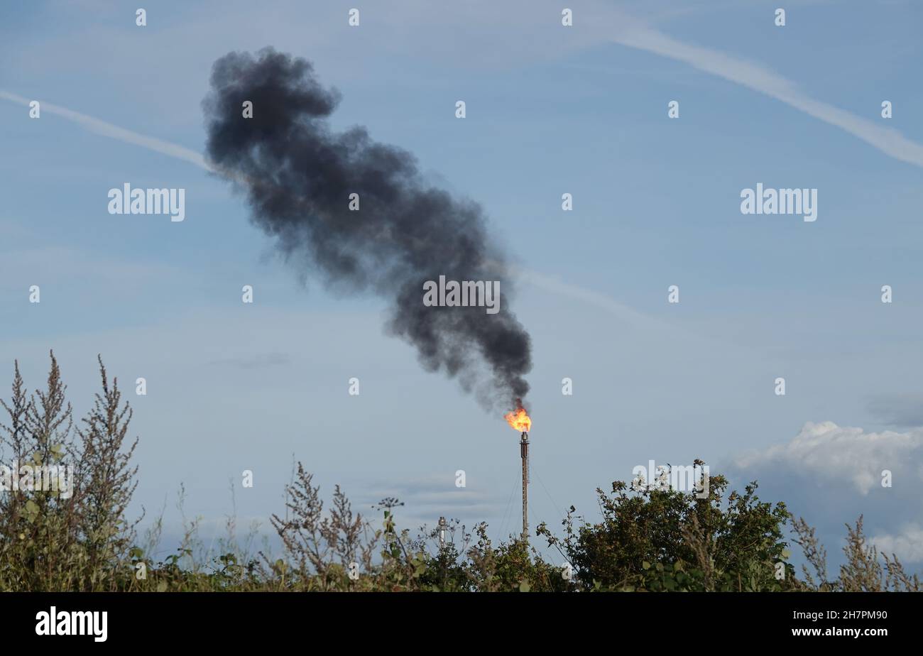 Smoke and flames from an industrial chimney polluting the air Stock ...