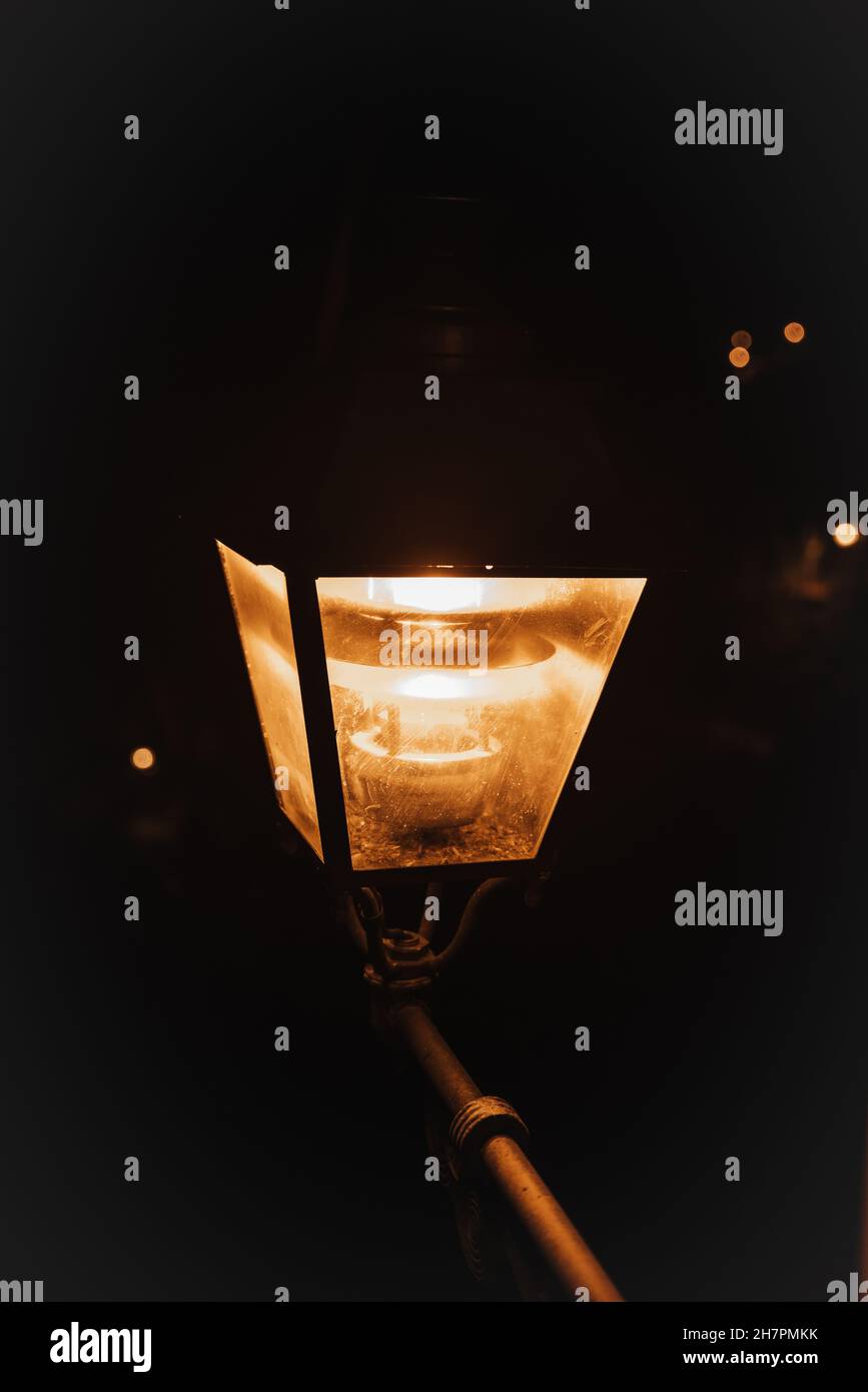 Vintage old street lamp lit at night outside Stock Photo - Alamy