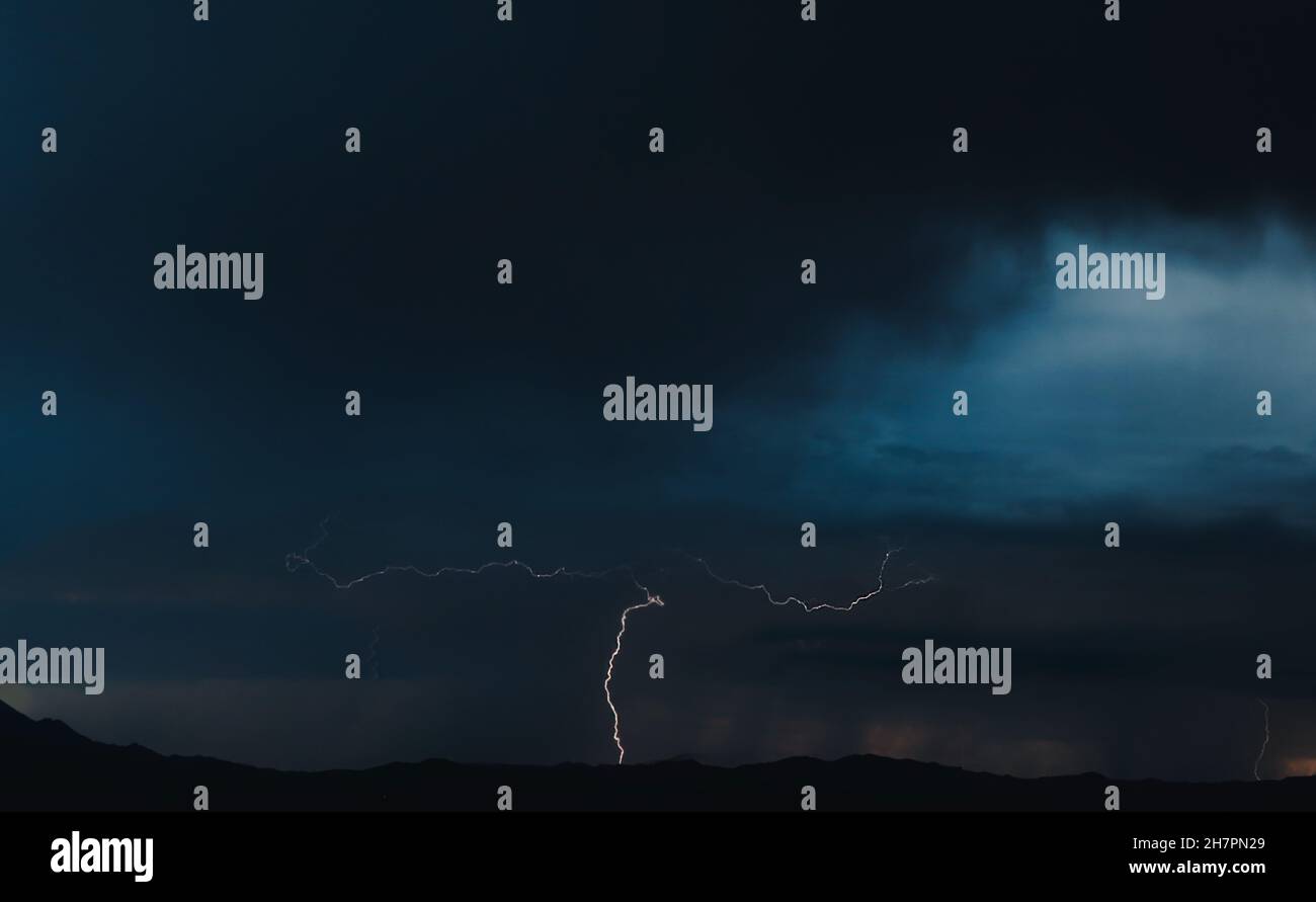 Breathtaking shot of lightning on a navy blue sky Stock Photo - Alamy
