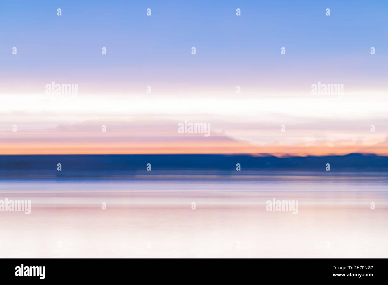 Intentional camera effect blurred scene with hint of land and clouds on ...