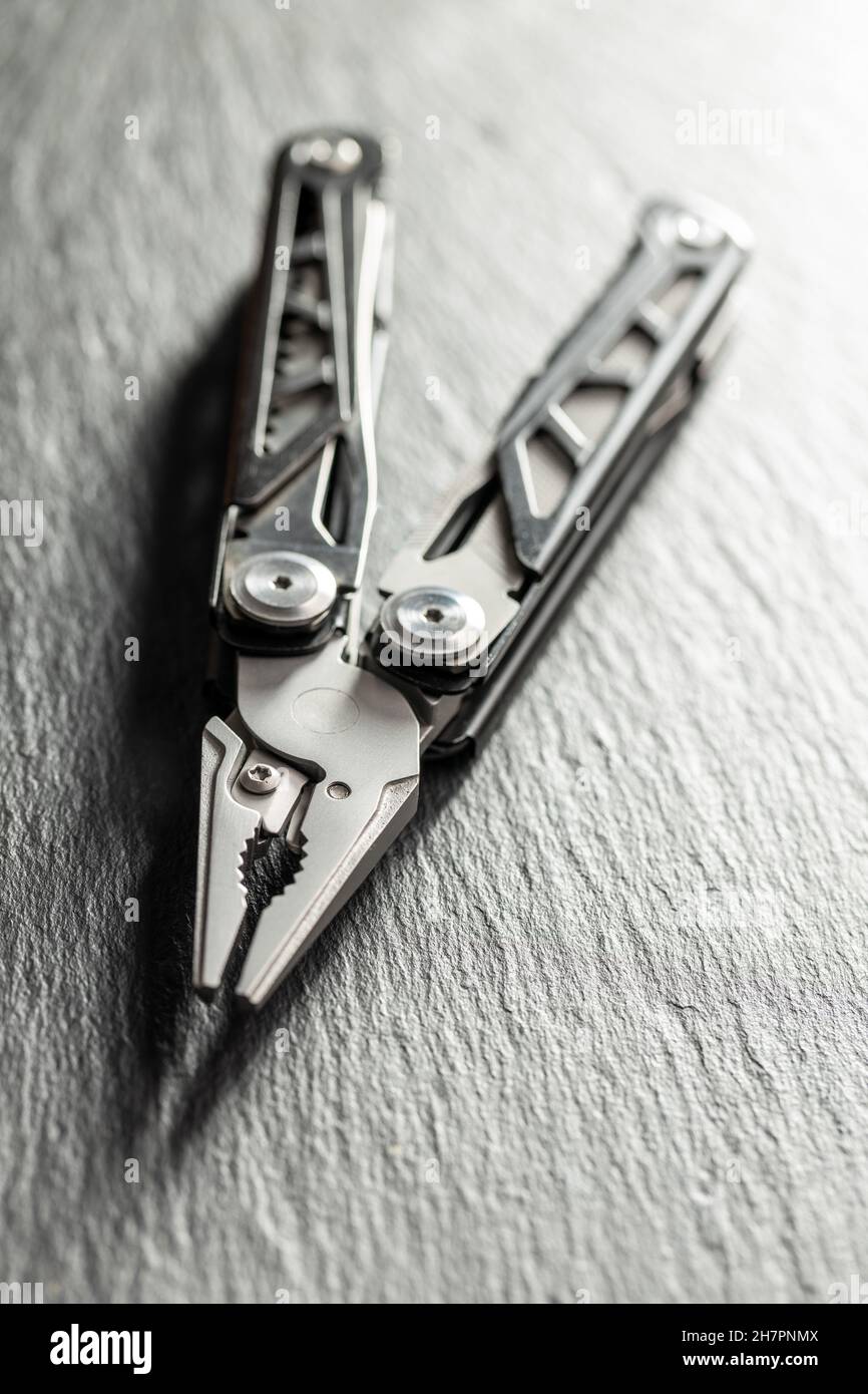 Multi-tools pliers with other tools and knife. Multifunction pliers on ...