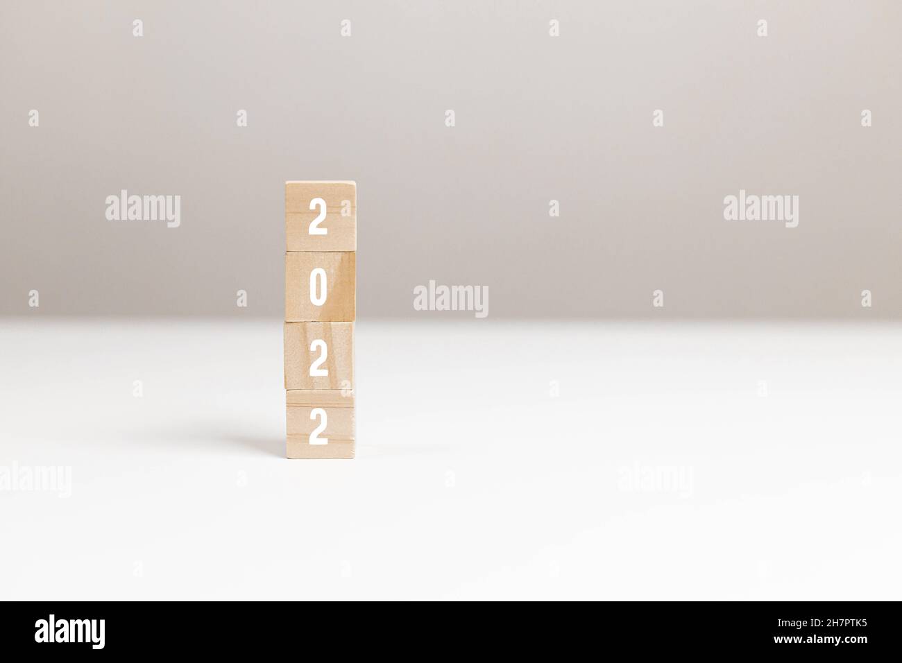 Wooden blocks with message 2022 Number on white table on light ...