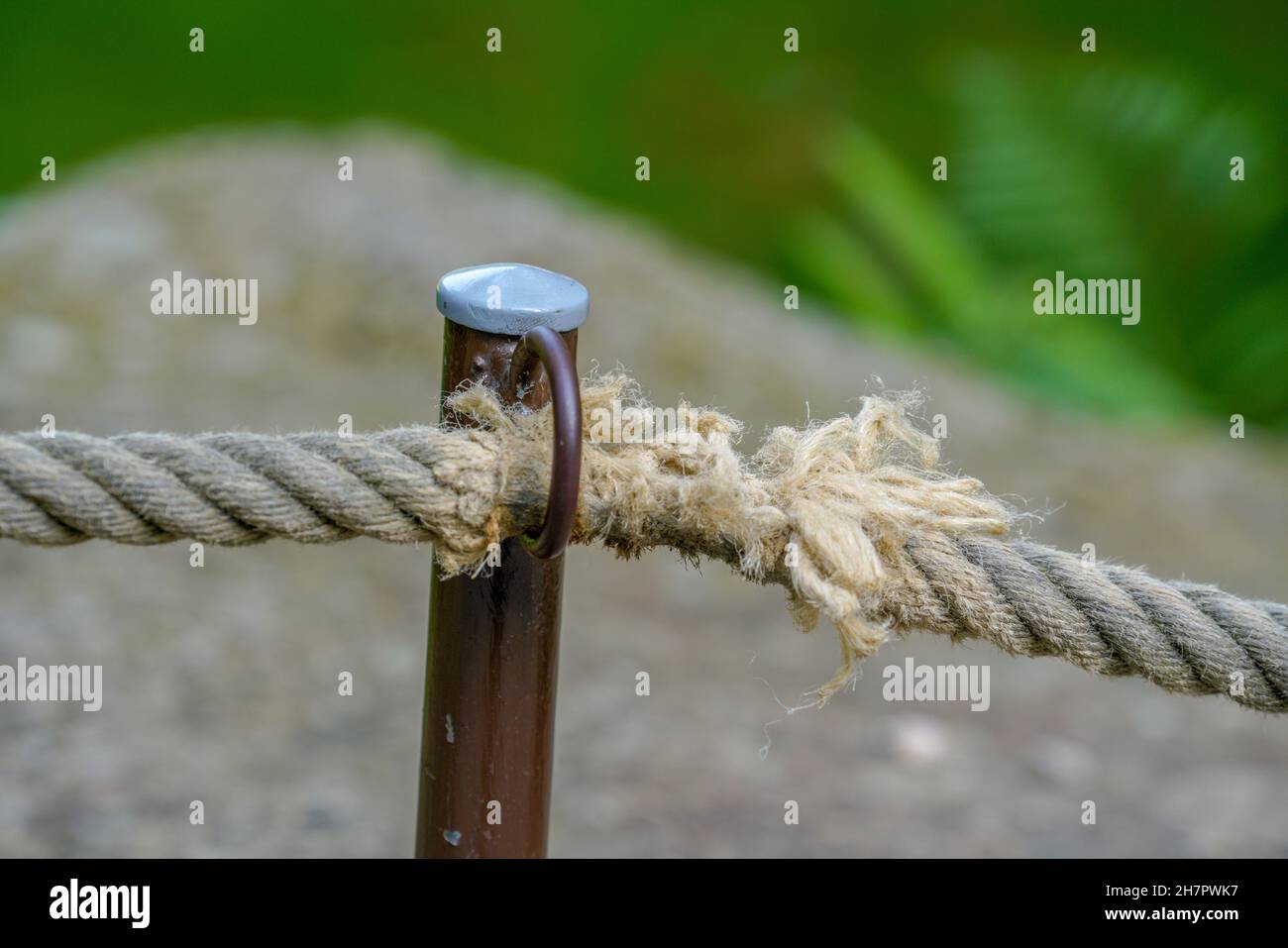 Rope fence with a metal pin bracket Stock Photo - Alamy