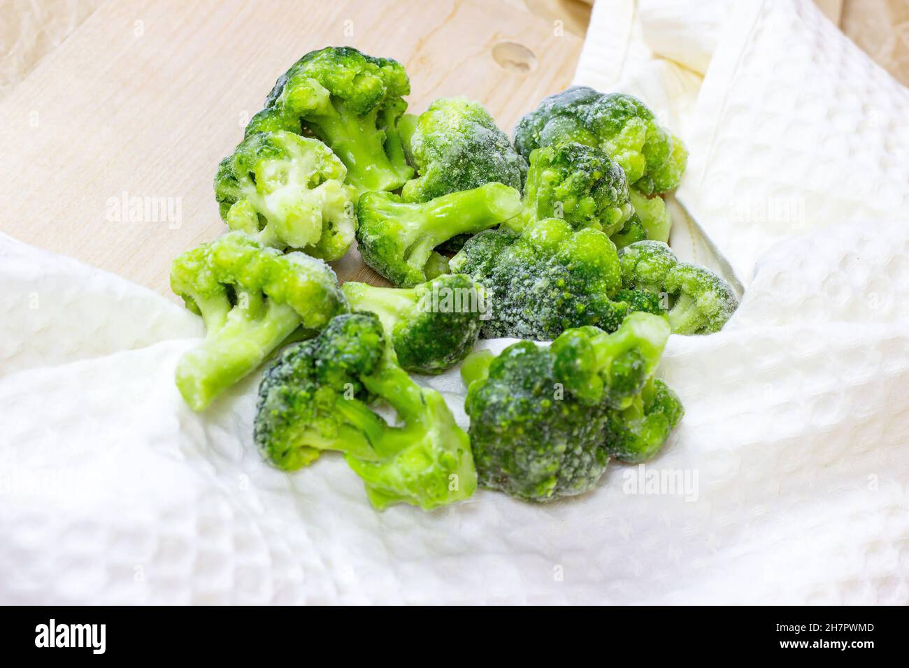 Fresh green frozen broccoli on light background Stock Photo - Alamy