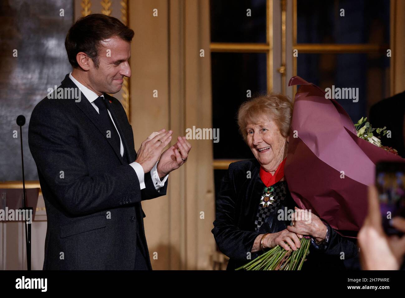 French President Emmanuel Macron (L) awards with the Medal of Honor ...