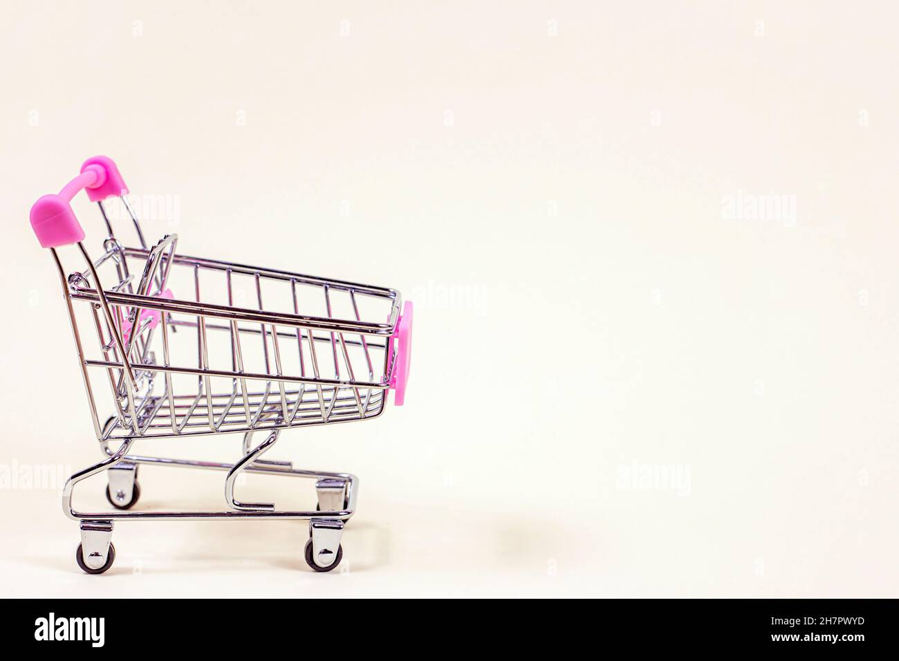 Pink empty shopping cart from the supermarket as a symbol of ...
