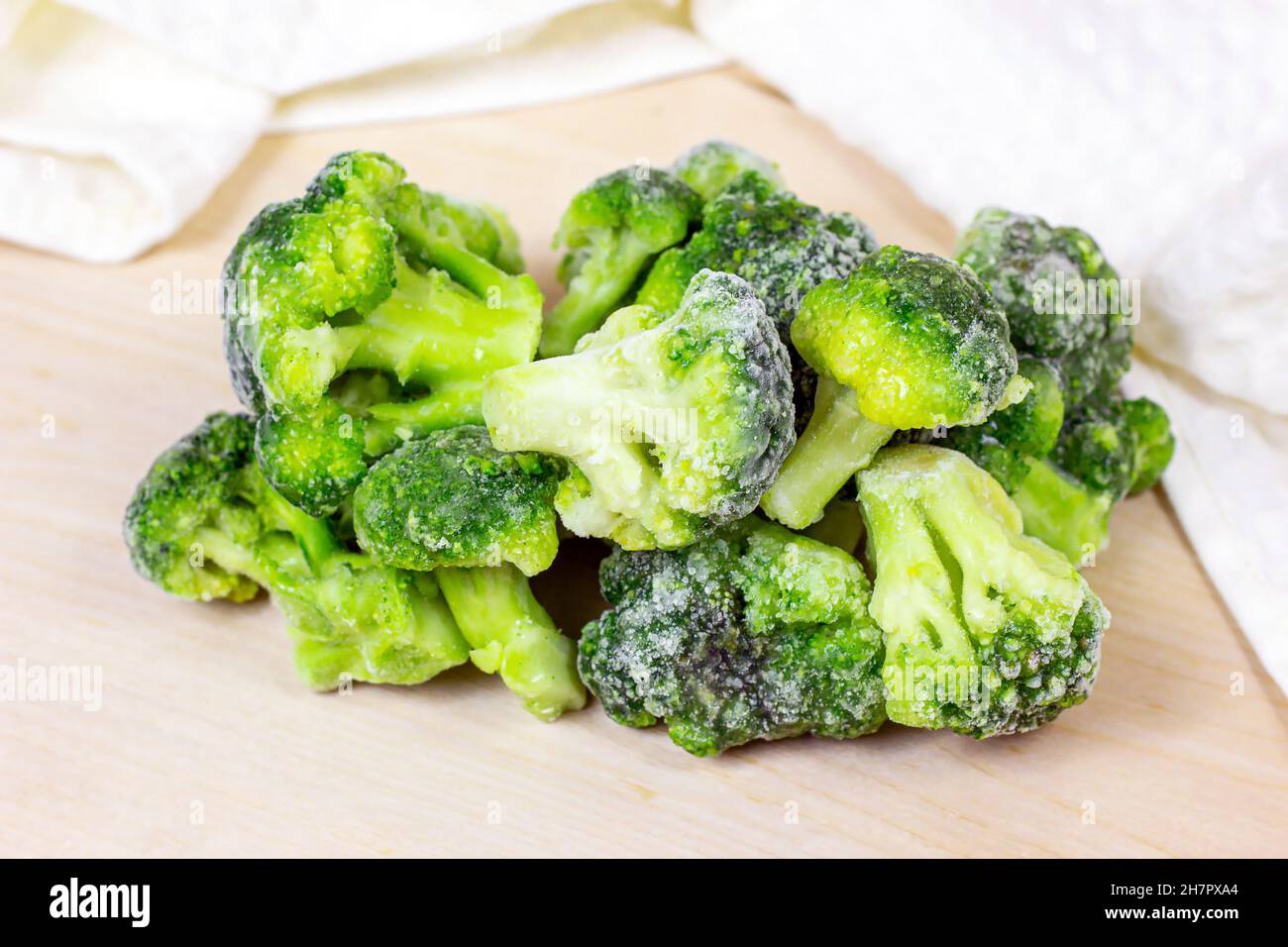 Fresh green frozen broccoli on light background Stock Photo - Alamy