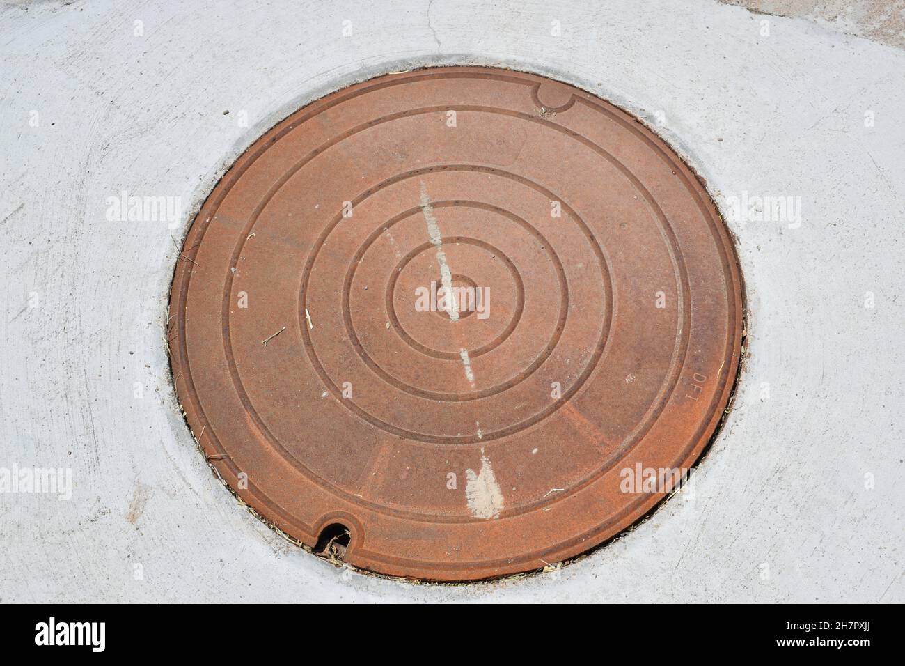 A large metal generic manhole cover Stock Photo - Alamy