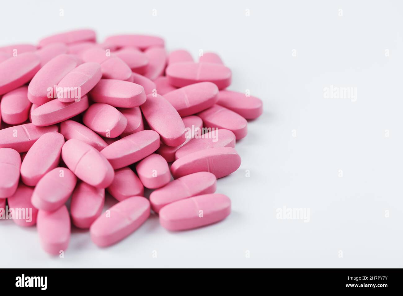 Pink pills with multivitamins on a white background. Free space Stock ...