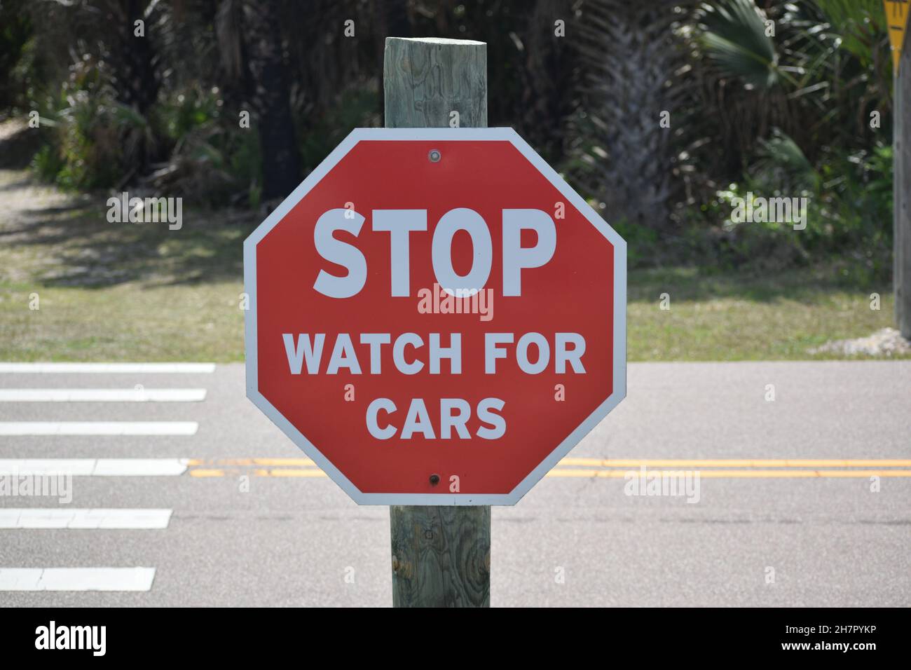 A sign instructs pedestrians to stop for automobiles Stock Photo - Alamy