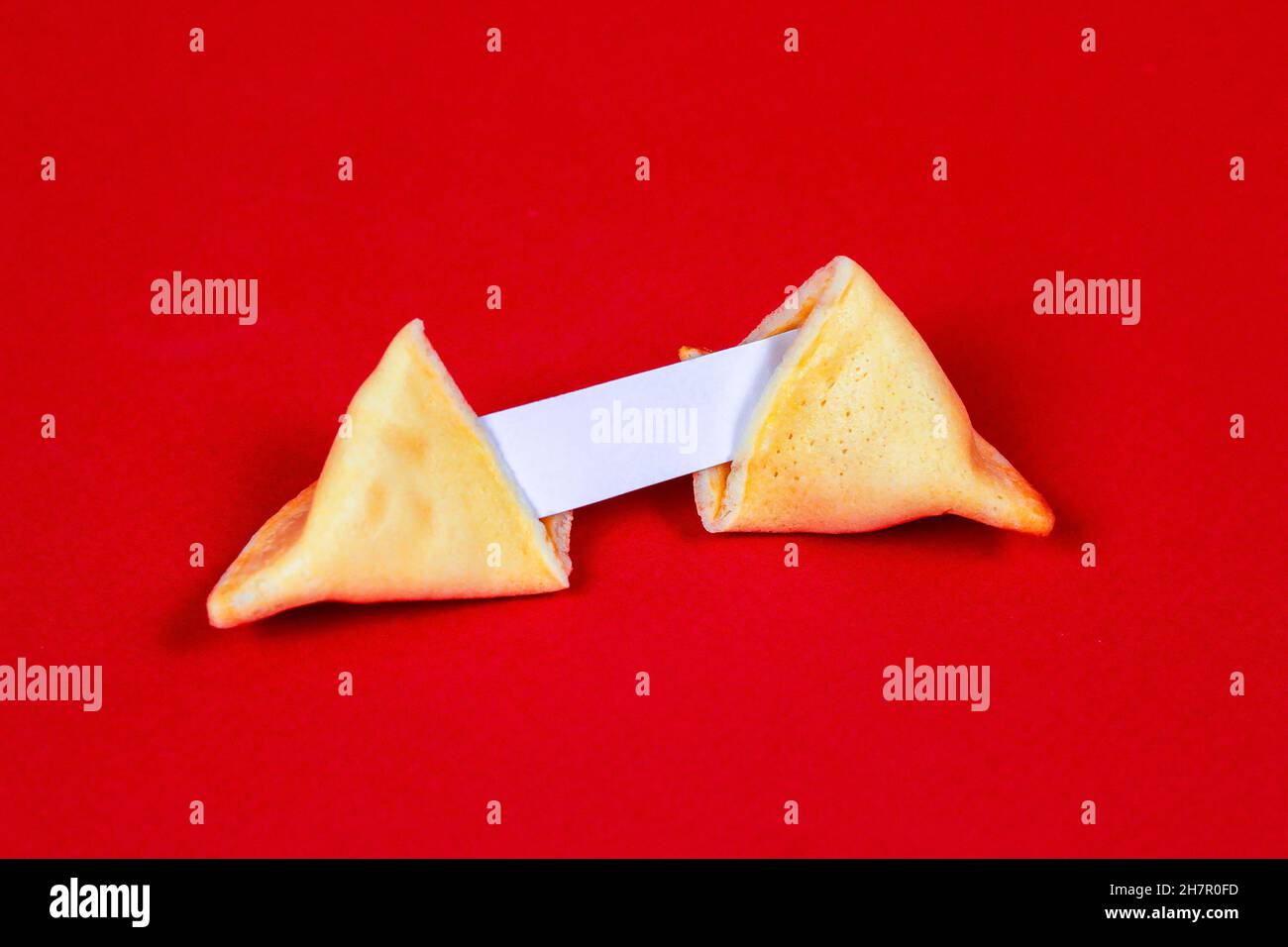 Fresh baked yellow Chinese fortune cookies with white blank note inside ...